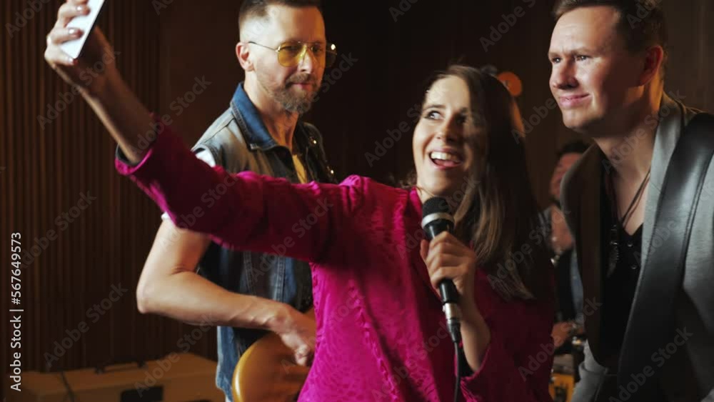Female vocalist taking a selfie with the guitarist while performing on ...