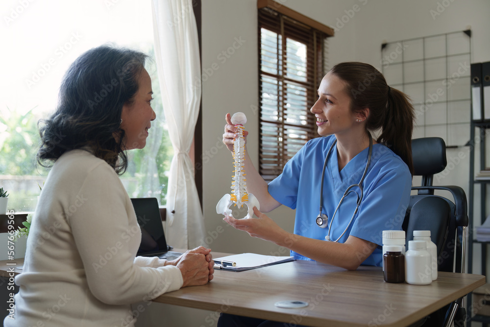 Professional Doctor explain on area of bone model joint at clinic ...