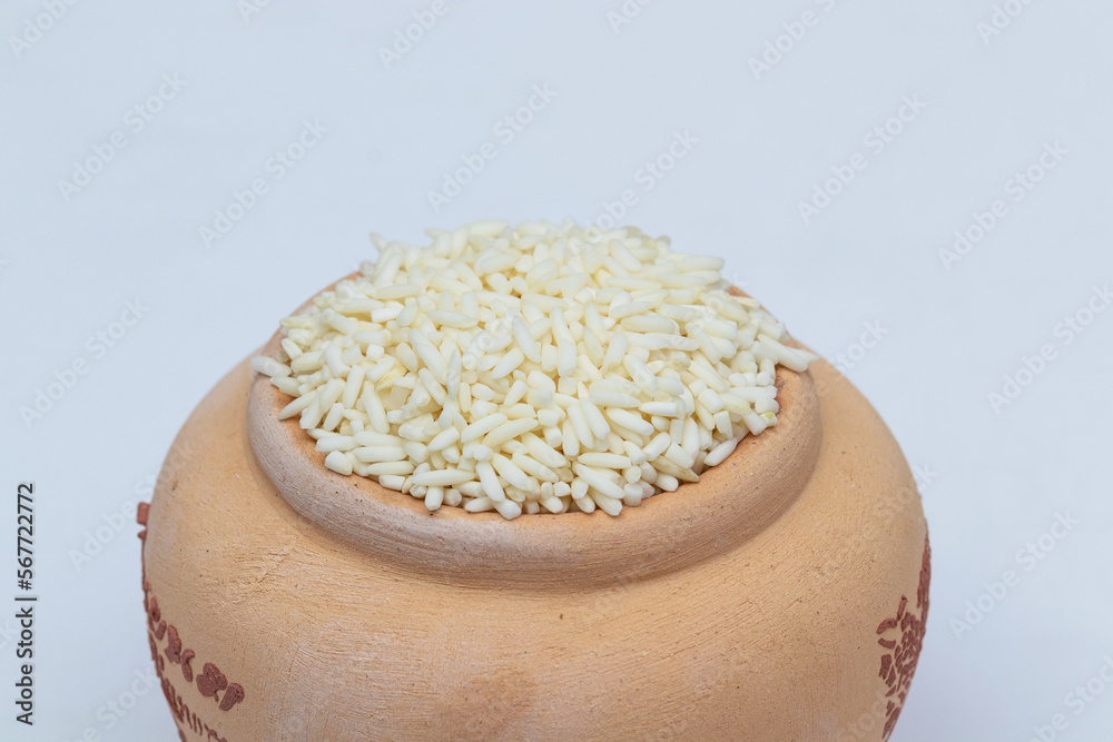 Grain sticky rice in clay pot on white background. Rice is cereal that ...