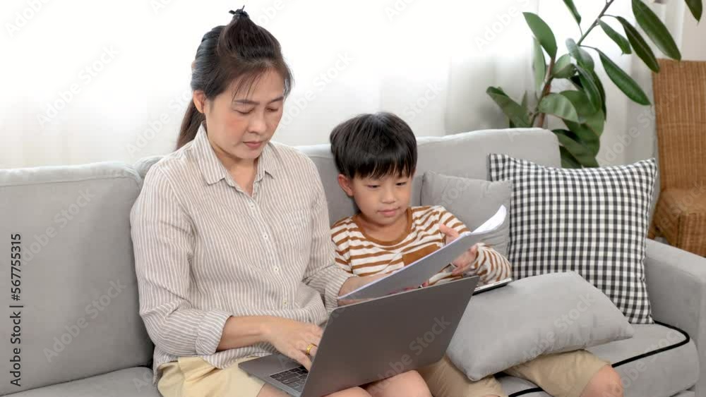 Asian little boy disturbed mother while single mom using laptop for ...