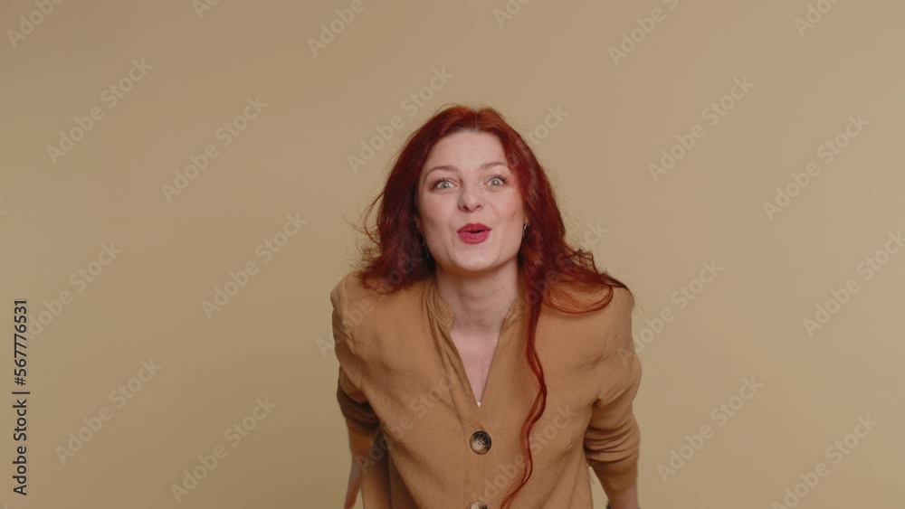 Wow. Hello, welcome. Redhead woman appear from below waving hi with her ...