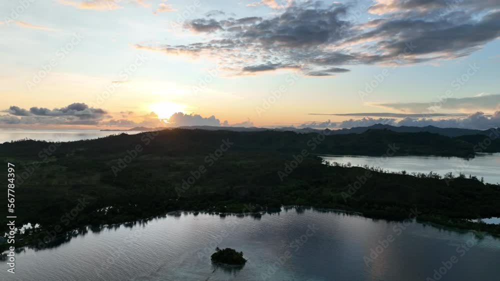 A serene sunrise illuminates tropical scenery in the Solomon Islands ...