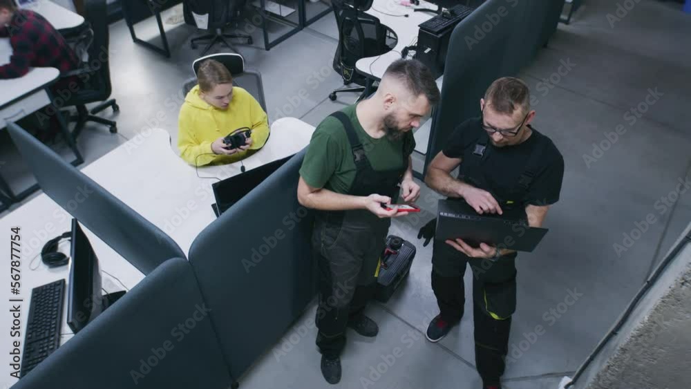 People working at office with modern design and sitting by tables with ...