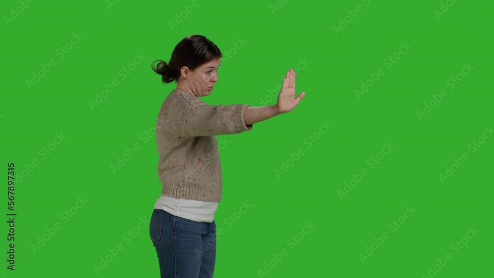 Side view of young woman raising palm as rejection gesture, expressing ...