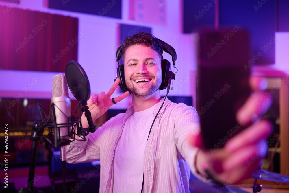 Singer in recording studio, selfie and portrait with peace hand sign ...