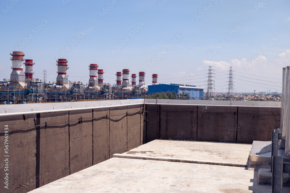 Landscape photo of roof top power plant building with blue sky. The ...