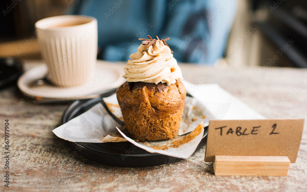 unwrapped cupcake on a table in a cafe with coffee Stock Photo | Adobe ...