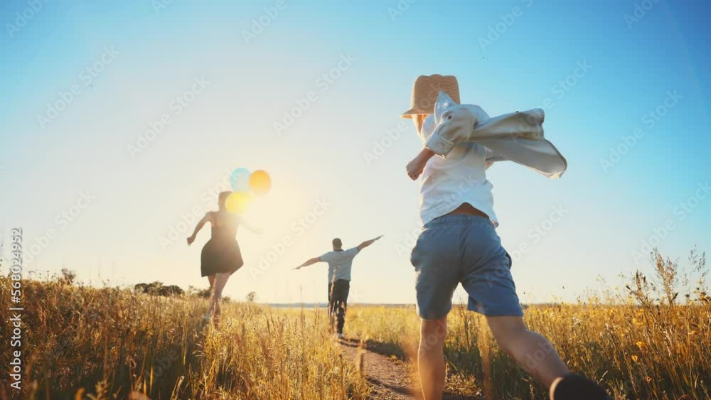 Active happy family run together on wheat field. Enjoy summer walk in ...