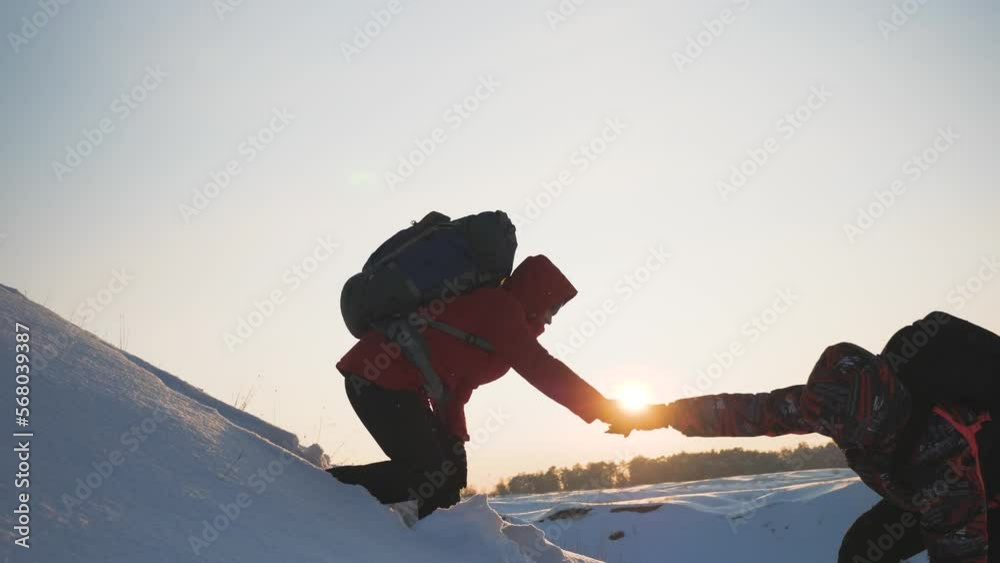 travelers climb snowy mountain sunset winter. hiking concept winter ...