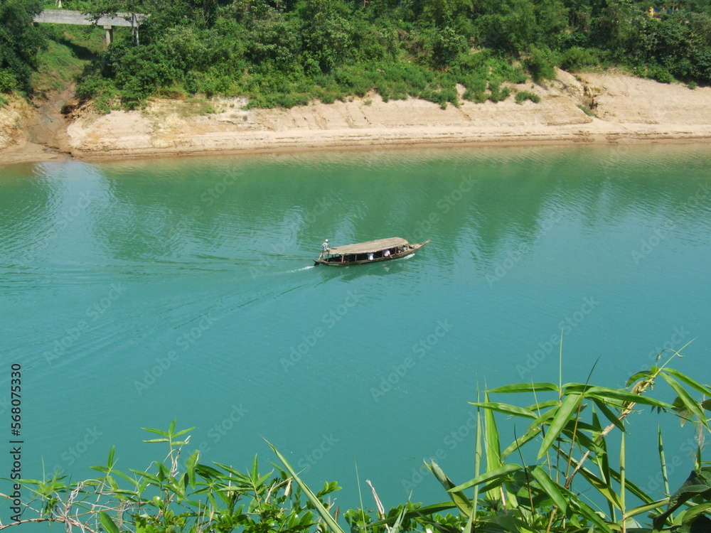 The boat, the green water river, and the hills of Lalakhal, a popular ...