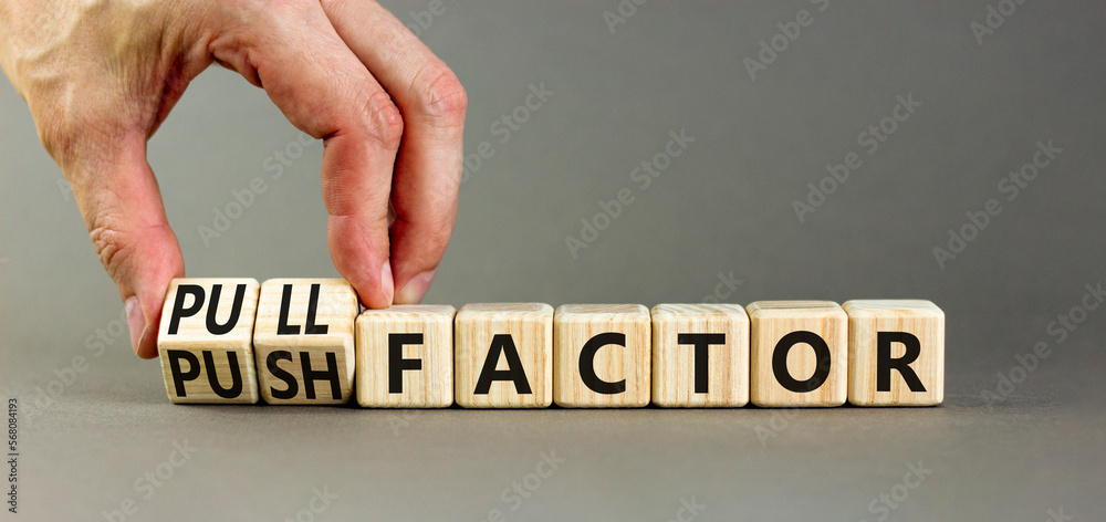 Pull or push factor symbol. Concept word Pull factor and Push factor on wooden cubes. Beautiful ...
