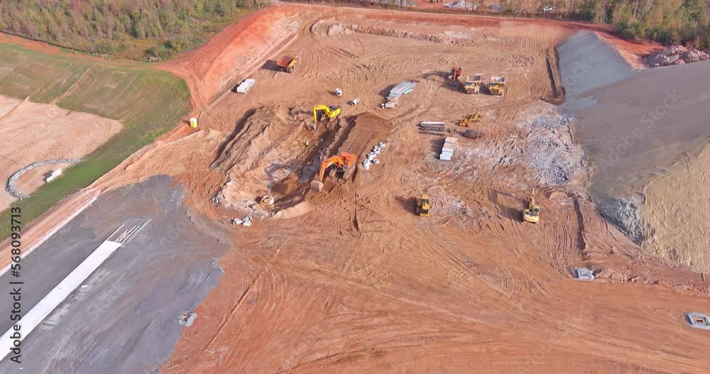 Excavator digging trenches for laying of underground storm sewer pipes ...