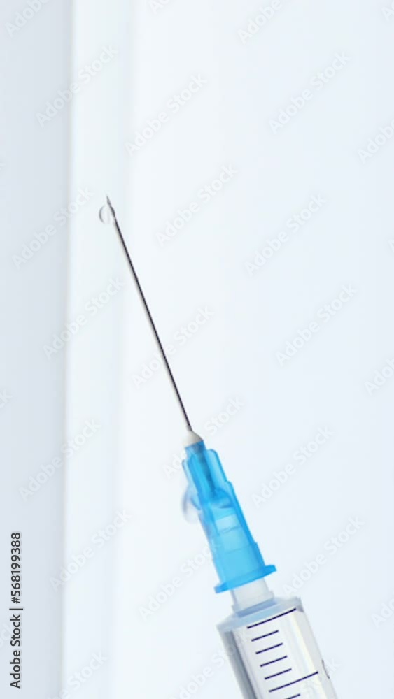 Vertical Screen: Close Up of injection liquid being in syringe ...