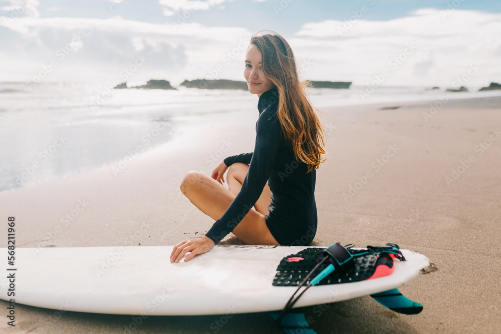 Stylish beautiful pretty young surfer girl in surf suit with white ...