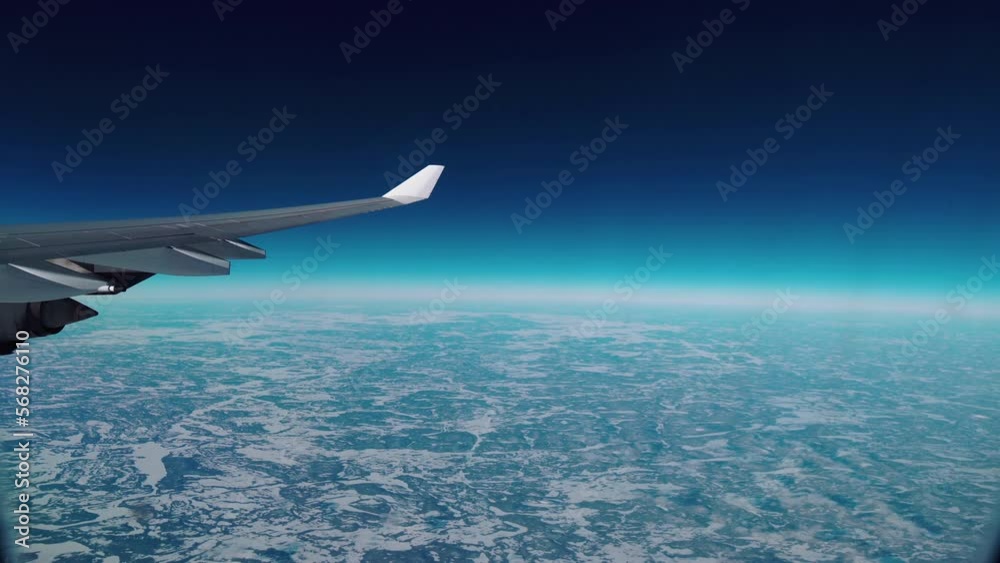 Airplane flight. Wing of an airplane flying above the clouds. Looking ...