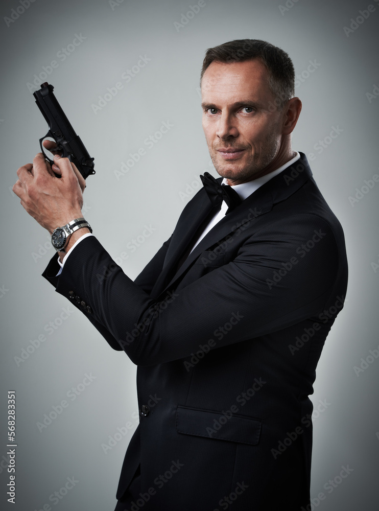 Portrait, gun and man in studio with weapon for power, crime or secret ...