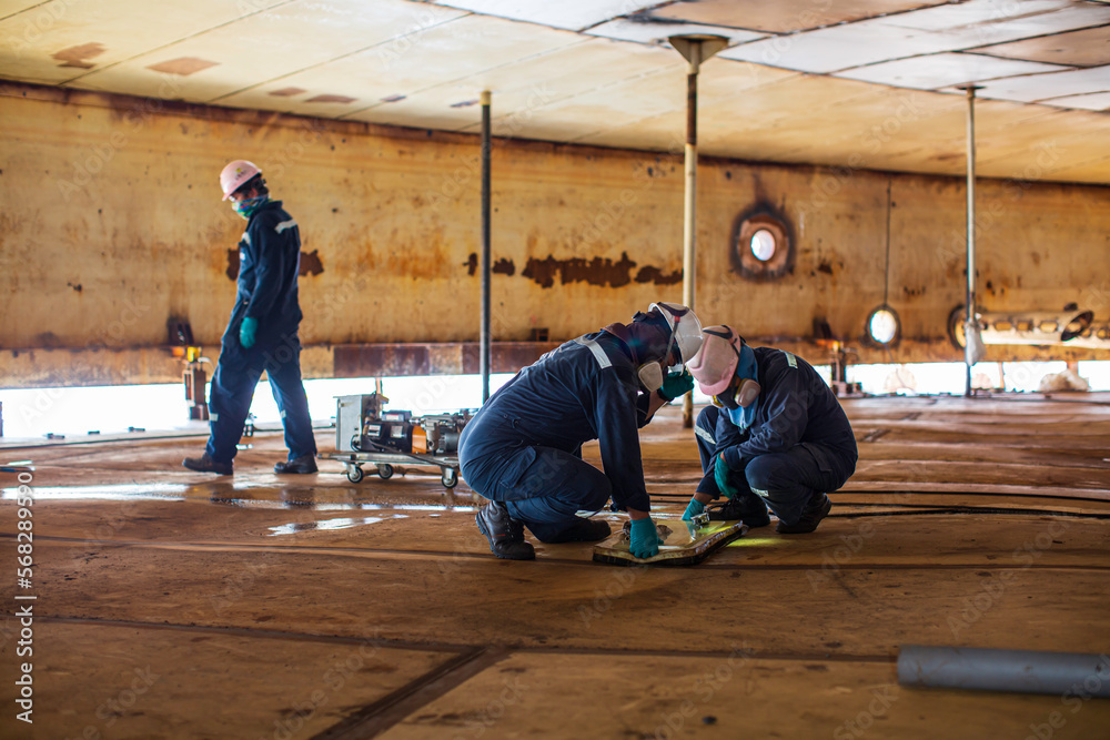 Poster Male worker inspection vacuum test bottom plate tank ...