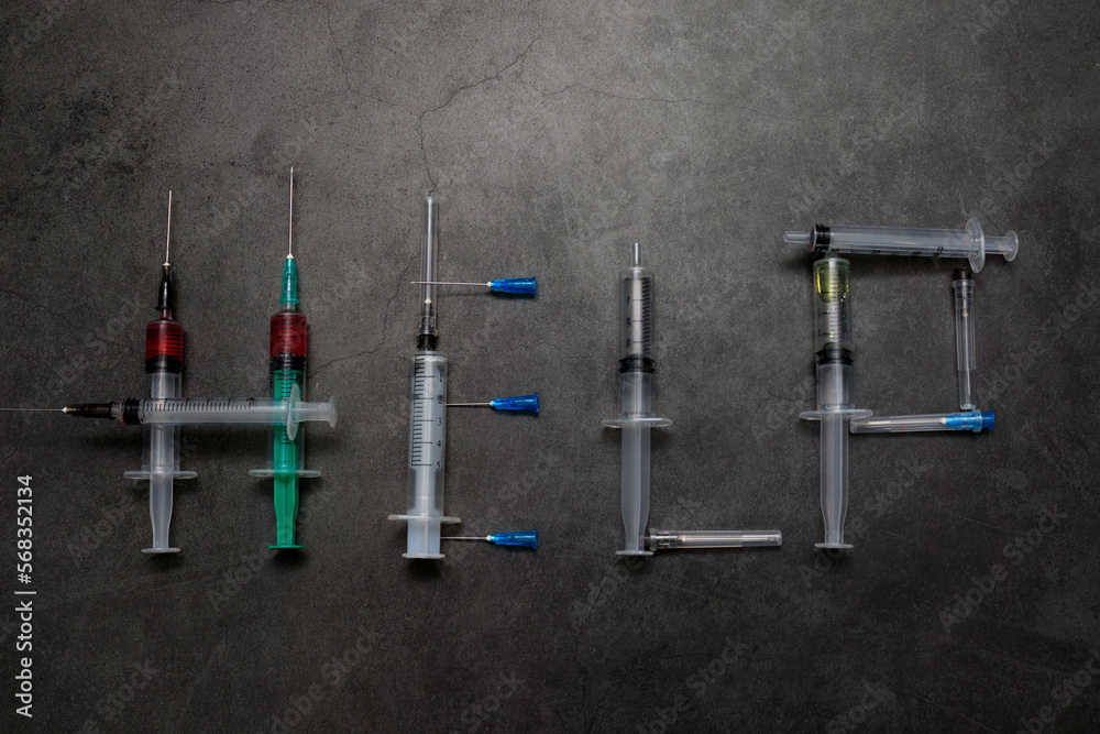 Syringes. The word help is laid out from used syringes. The concept of ...