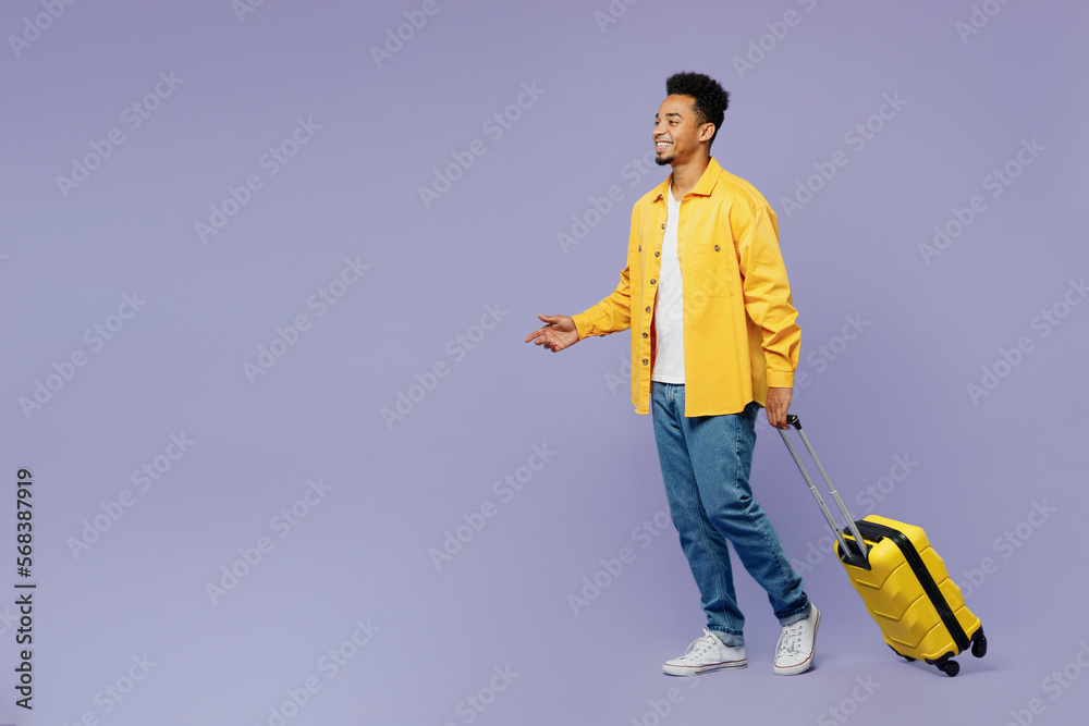 Full body side view traveler fun man wears casual clothes hold suitcase ...