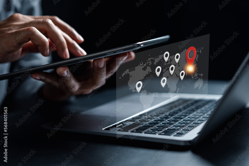 Businessman using smartphone synchronize computer searching world map ...