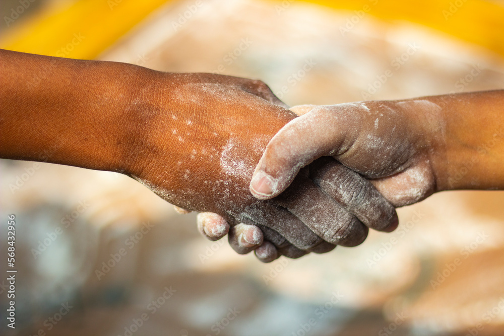 Here are two human hands and they are shaking hands and the background ...