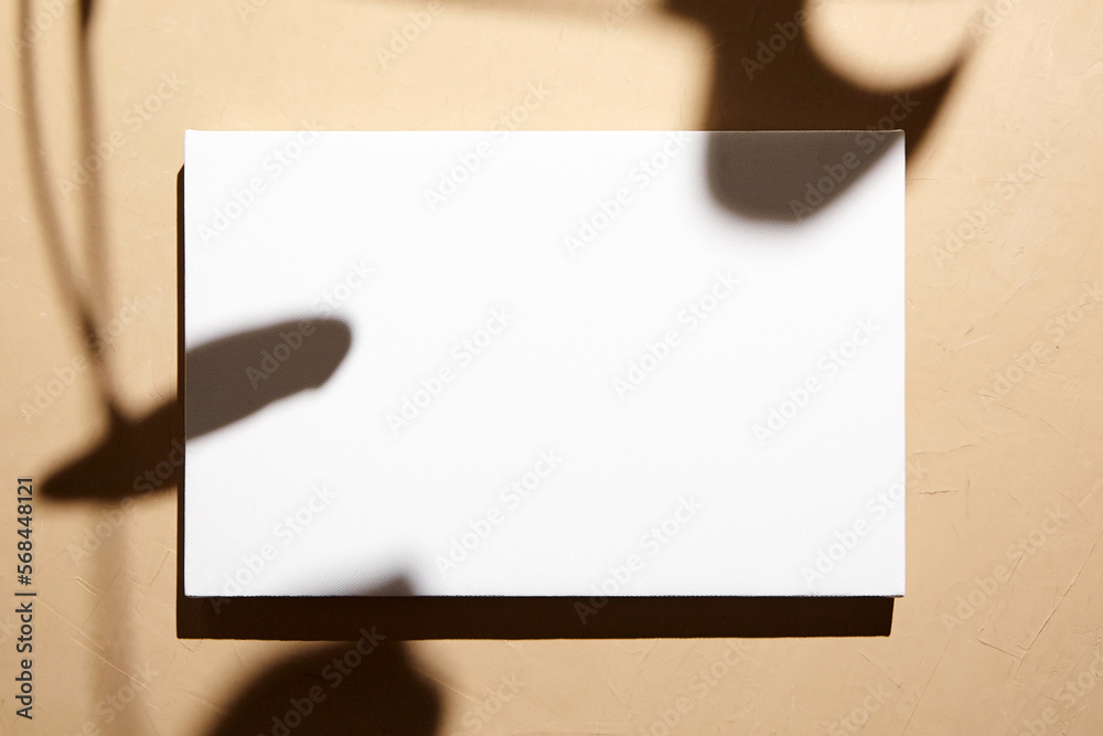 White canvas, blank picture mockup hanging on beige wall with dark ...