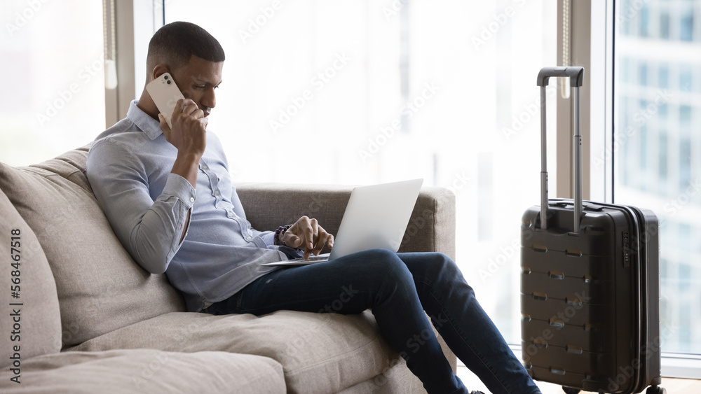 Busy young millennial travelling business man using digital gadgets for ...