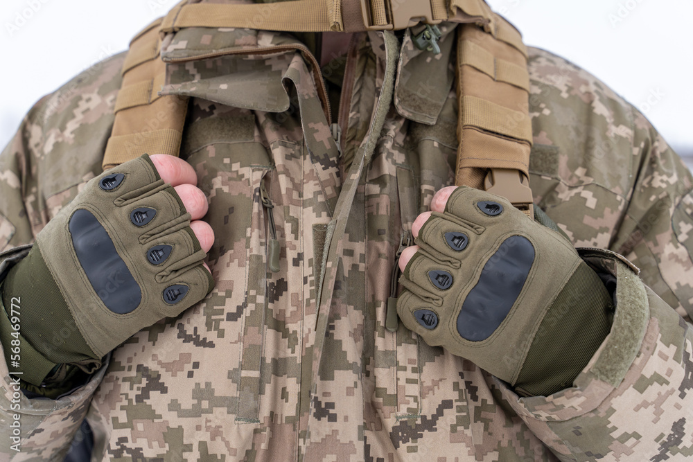 Ukrainian military man in winter uniform with tactical backpack and ...