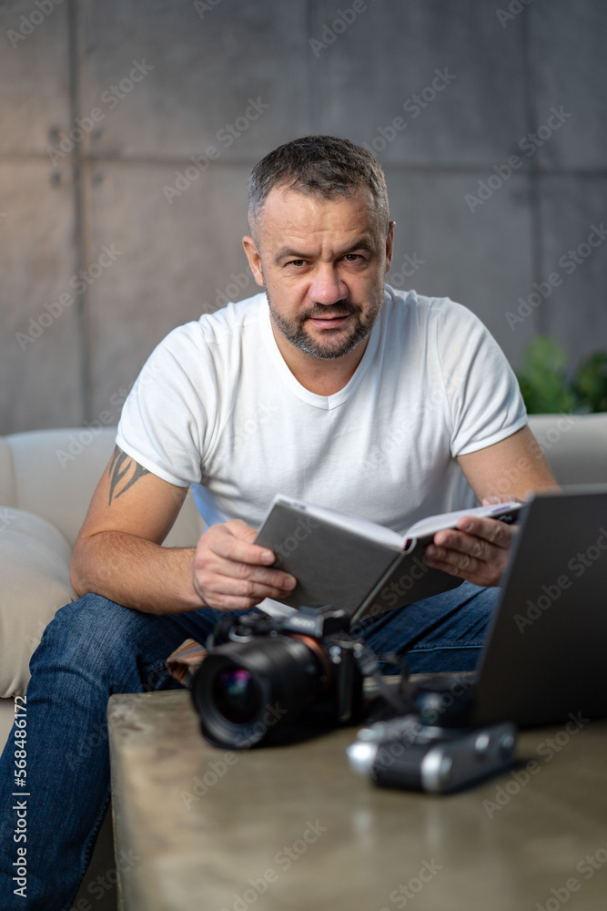 Bearded young confident guy stand behind office desk with laptop ...