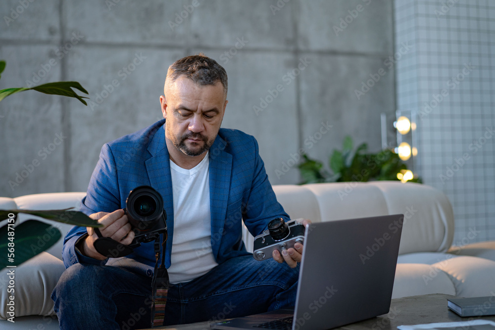 Bearded young confident guy stand behind office desk with laptop ...