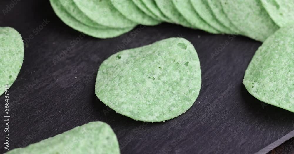 break crispy potato chips of green color, unusual potato chips of green ...