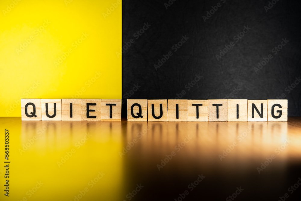 QUIET QUITTING word concept in wooden letters with black and yellow ...