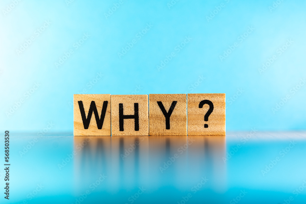 WHY word in wooden letters with light blue background. Uncertainy ...