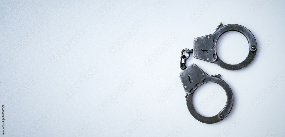 Closed police handcuffs on a white rectangular background. Banner for ...