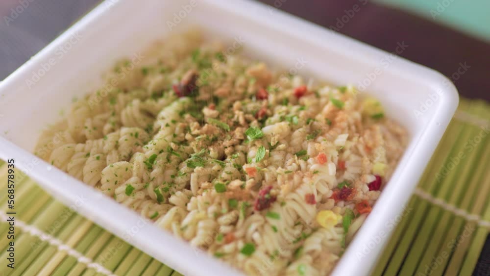 The image captures the process of preparing a common junk food meal of ...
