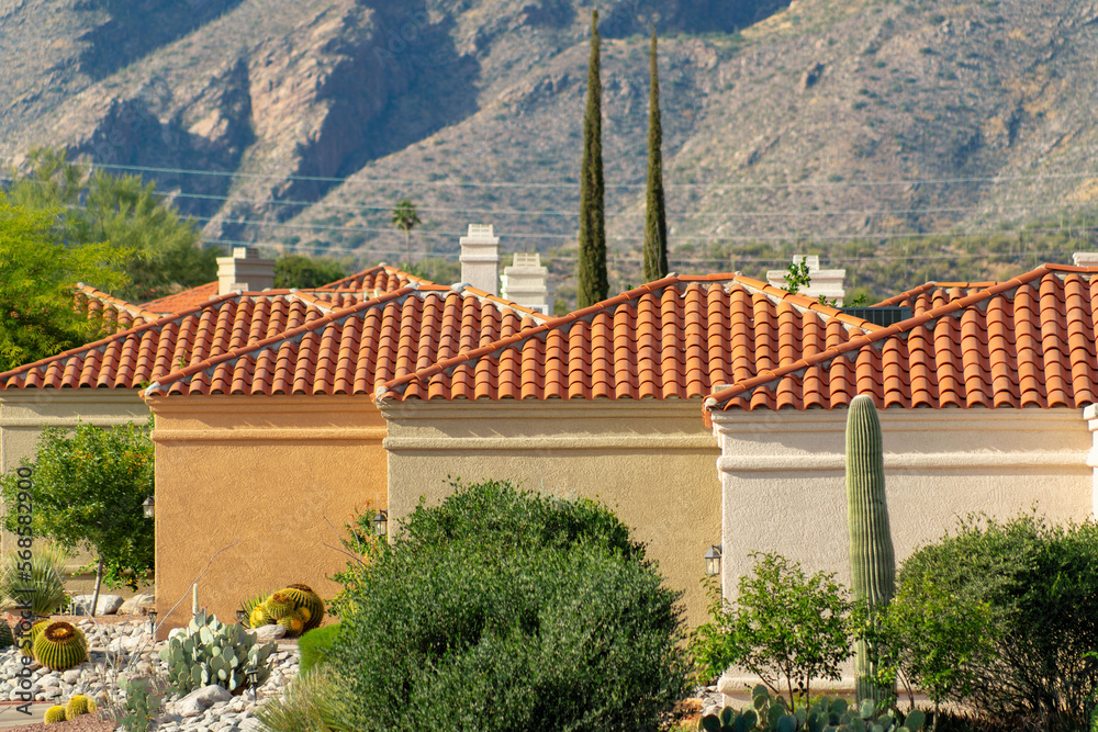 Row of box design houses with gable style roofs with adobe red roof ...
