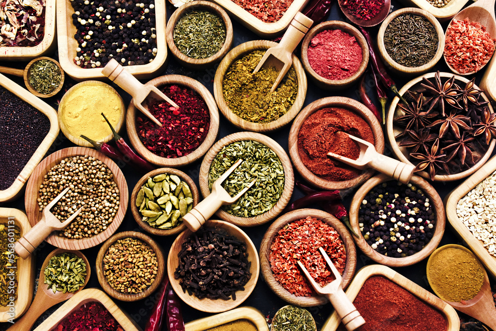 Colorful mix of herb and spice varieties: curry and coriander, turmeric ...