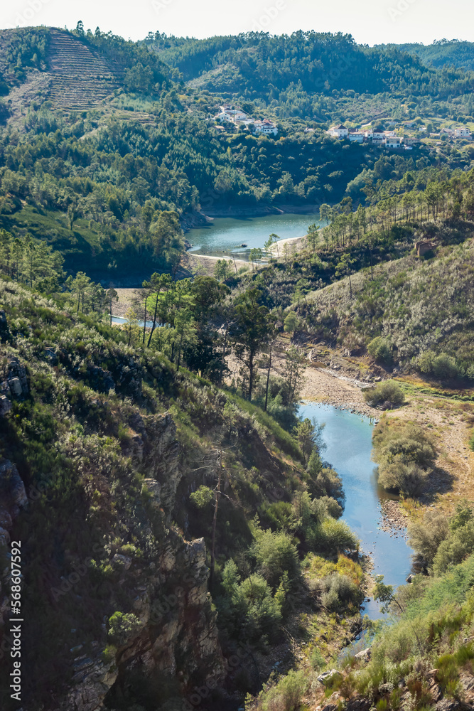 Rugged cliff with pine trees and vegetation and aerial view to Codes ...