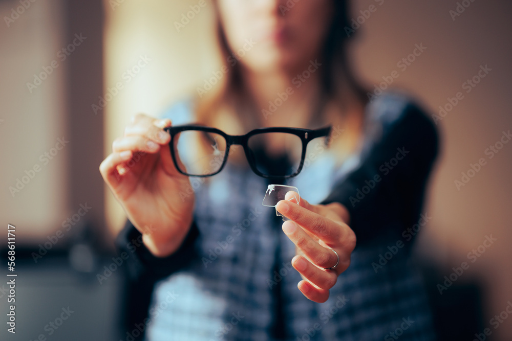 Foto de Woman Holding a Broken Pair of Glasses Showing Falling Lens ...