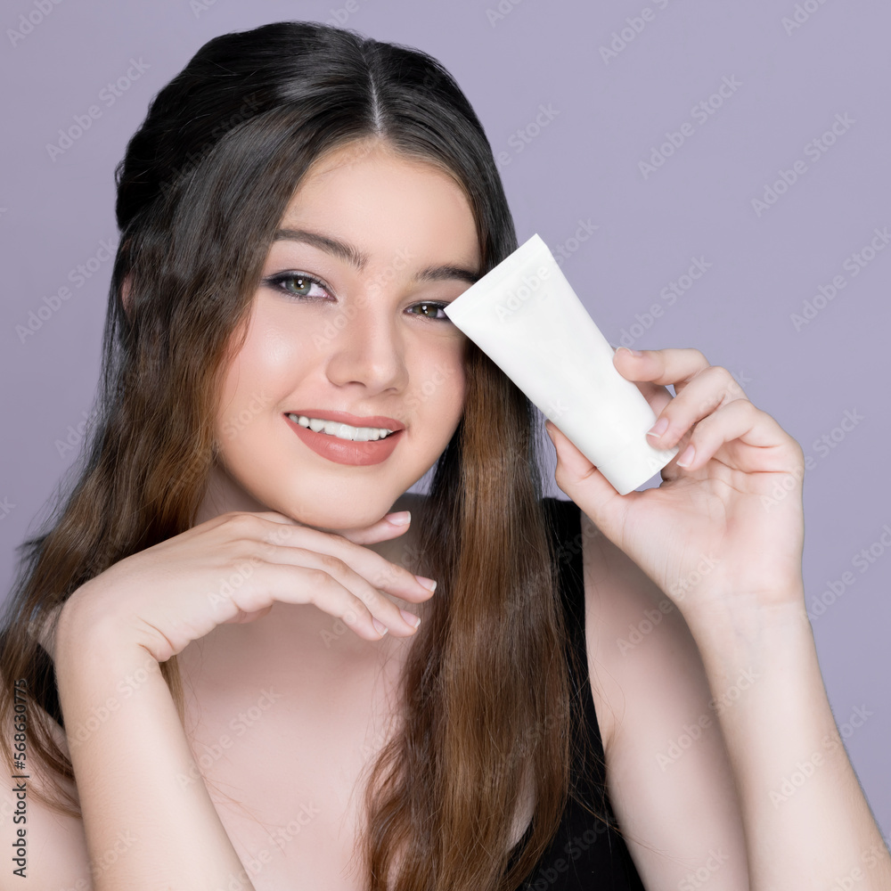 Young charming girl hold mockup moisturizer skincare cream tube or ...