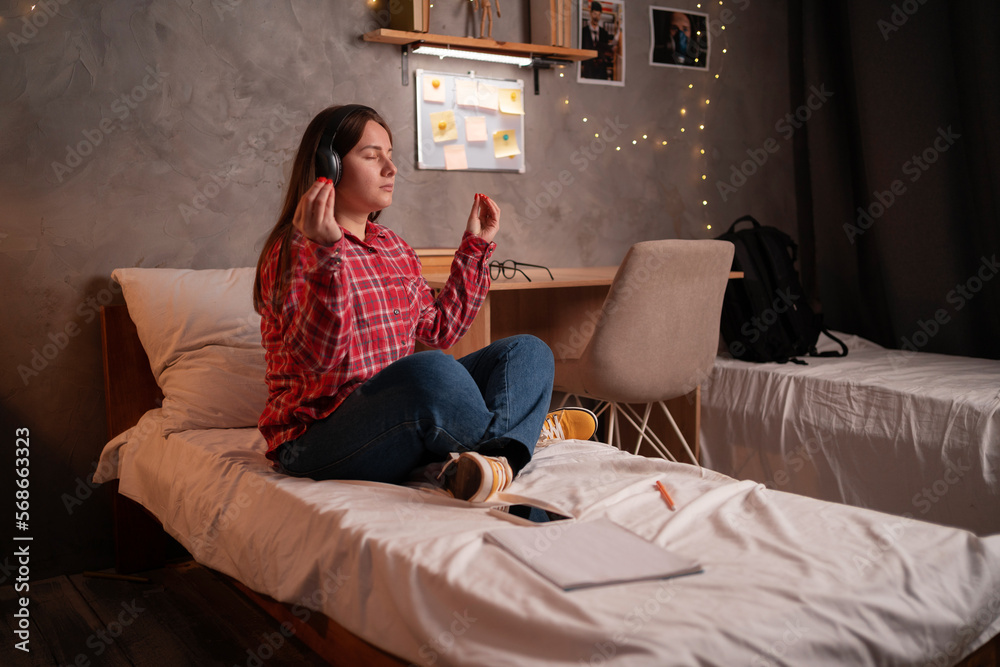 Full size photo of focused calm girl sit bed legs crossed folded ...