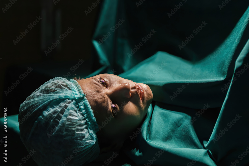 female asian patient wearing net waiting for surgeon to perform surgery ...