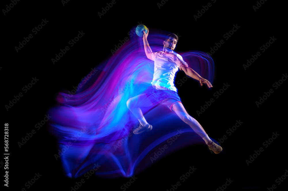 Throwing ball in a jump. Young man, professional handball player in ...