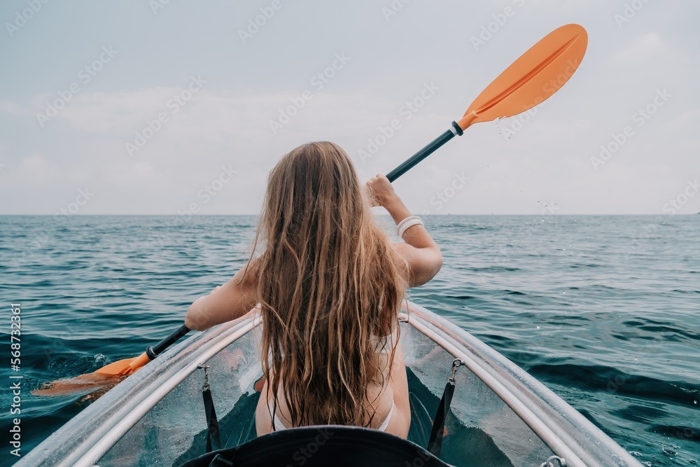 Woman in kayak back view. Happy young woman with long hair floating in ...