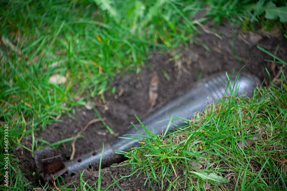 Rocket bomb lies buried in the green grass. Weapons of mass destruction ...