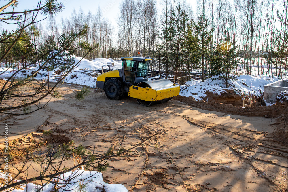 Powerful track paver stand on parking zone in snowy day. Track asphalt ...