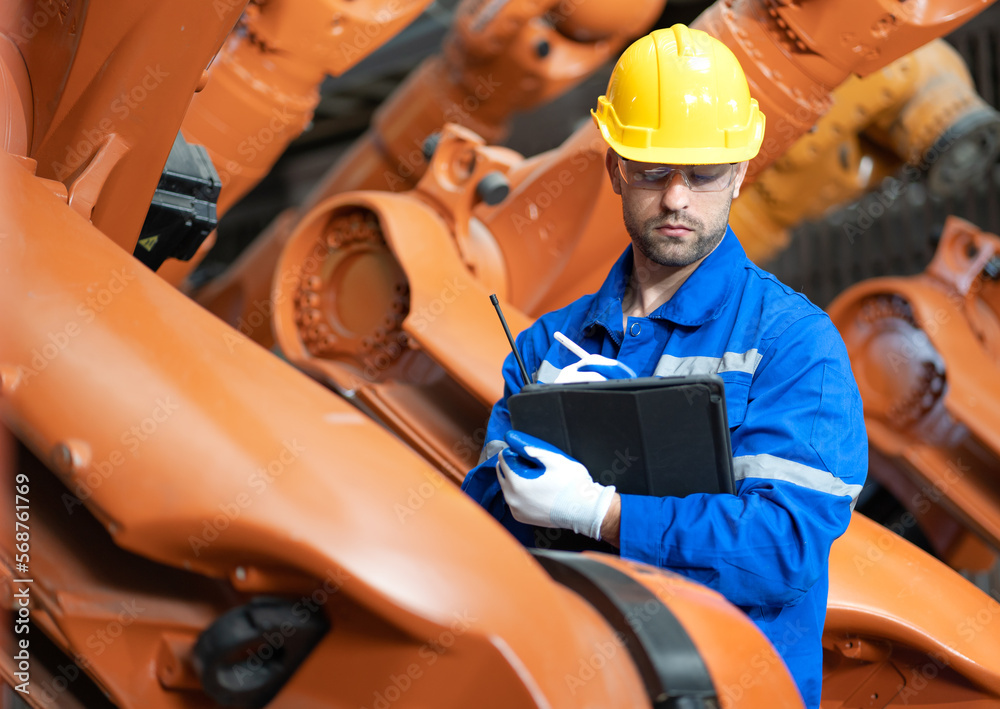 Industrial engineer checking mechanic part orange robot frame before ...