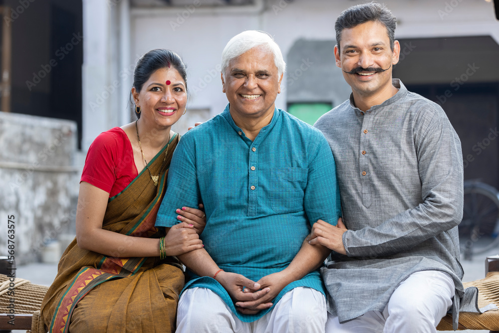 Happy Indian Couple Spending Time With Father At Home Stock Photo ...