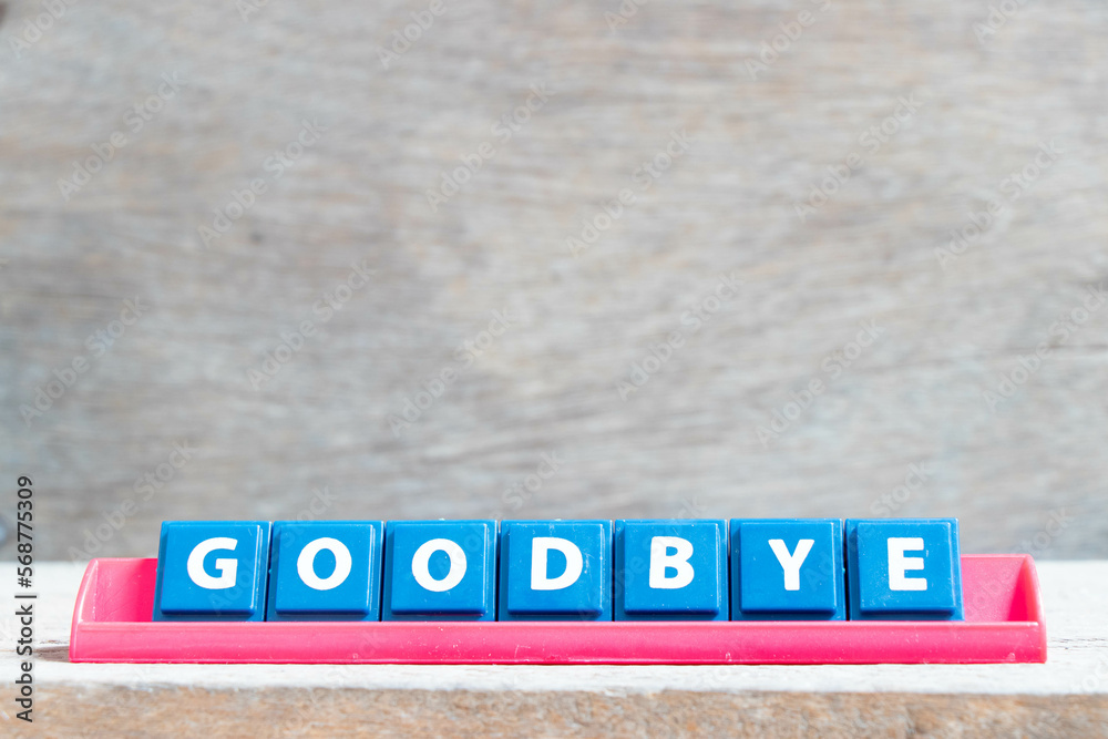 Tile alphabet letter with word goodbye in red color rack on wood ...