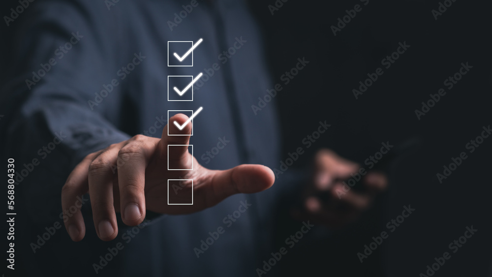 Businessman holding smartphone tick correct sign mark for document ...